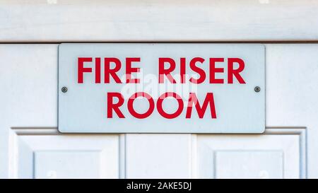 Panorama Fire Riser Room sign on the white wood door of a building with ...