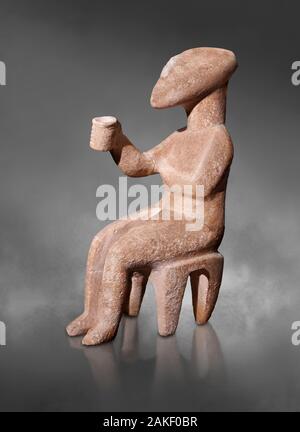 Rare male Cycladic statue of a seated warrior or hunter holding a cup ...
