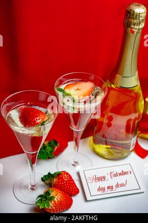 Valentines day greeting card with champagne, gift box and candy hearts ...