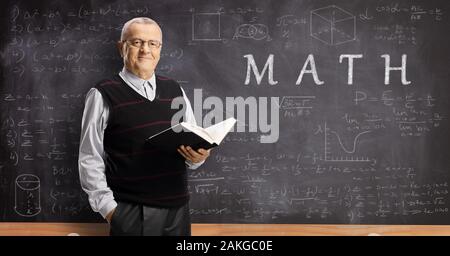 Senior male math teacher in time management concept Stock Photo - Alamy