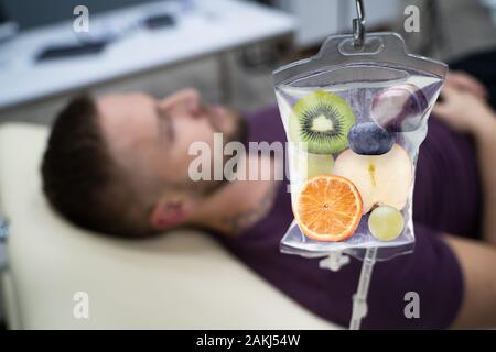 Man In In Hospital Getting IV Infusion Of Fruit Slices Inside Saline ...