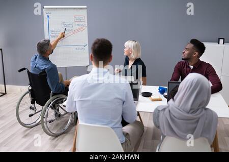 Disabled Mature Businessman Giving Presentation To His Colleagues Stock ...