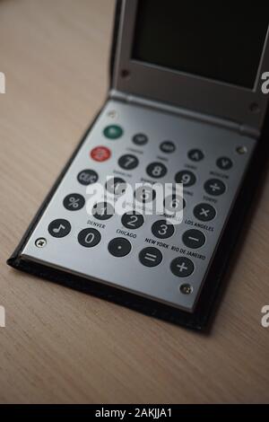 Metal folding calculator, close-up of buttons with numbers and names of ...
