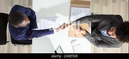 Businessmen shaking hands. Top View Stock Photo - Alamy