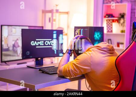 Upset professional gamer because he lost an important game. Room full ...