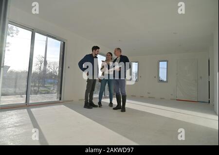 Young couple visiting house under construction Stock Photo - Alamy