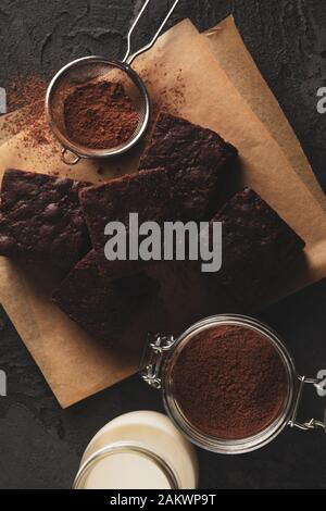 Chocolate cake slices, almond and strainer on white background, close ...