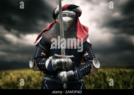 Mediaeval knight with sword in heavy armor metal harness, isolated on ...