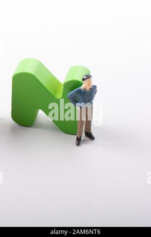 Tiny figurine of men beside colorful wooden letters say MAN Stock Photo ...