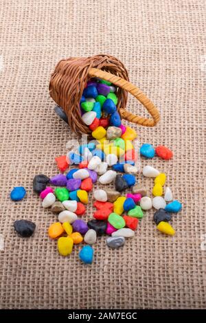 Basket of colorful pebbles spill on background Stock Photo - Alamy