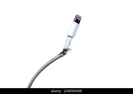 The broken and frayed cable from the charger for the smart phones ...