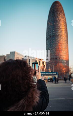 Tourist make a photo by a phone on the high mountain top. Adventure and ...