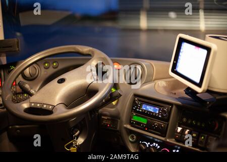 Cockpit or cabin of public transport, bus driver holding steering wheel ...