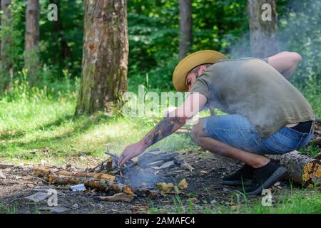 How to build bonfire outdoors. Arrange the woods twigs or wood sticks ...