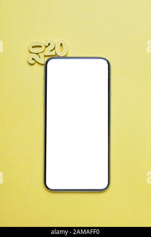 Top view of smartphone mock up on female hands over blue background ...