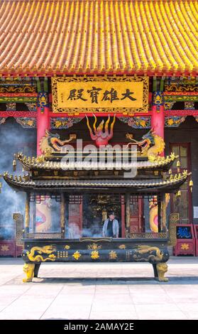 An incense burner within the Jile Temple complex on a sunny spring day ...