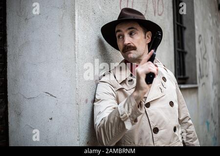 Detective taking cover and aiming with his handgun Stock Photo - Alamy