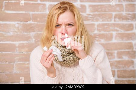 Having the sniffles. Cute woman nursing nasal cold or allergy. Sick ...
