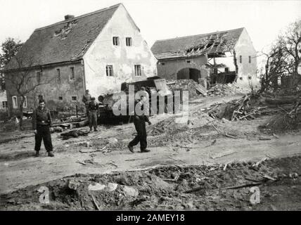 German SS troops with the 1st Panzer division check a highway sign at ...