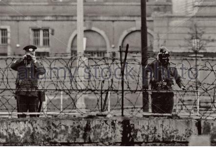 BERLIN WALL East German guards look on as the Berlin Wall is Stock ...