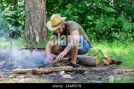 How to build bonfire outdoors. Arrange the woods twigs or wood sticks ...