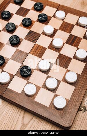 High angle shot of a checkers board with a black piece Stock Photo - Alamy
