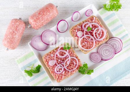 german sandwich mettbrotchen ground pork, bun and raw meat with onion ...