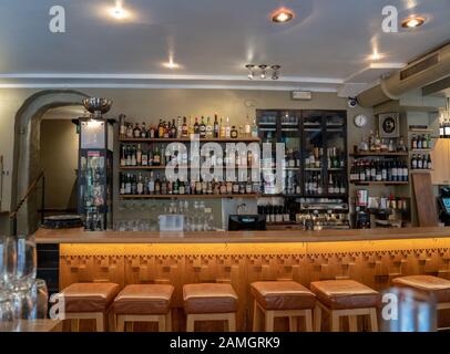 Behind bar display of shelves with bottles of alcohol Stock Photo - Alamy
