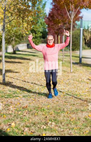 Senior runner man arms up after running Stock Photo - Alamy