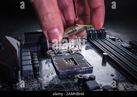 Installing modern central processor unit into motherboard Stock Photo - Alamy