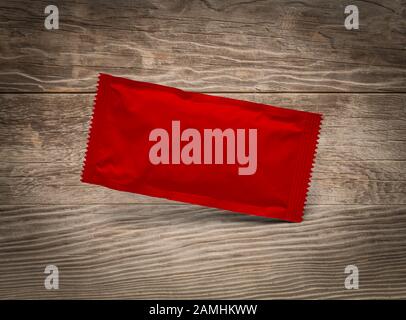 Blank Red Condiment Packet Floating on Aged Wood Background Stock Photo ...
