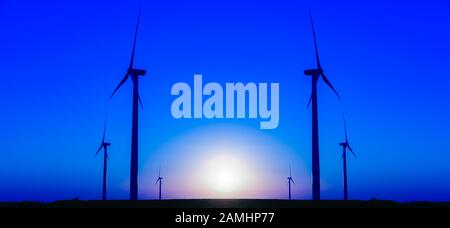 Mirror image silhouette of large wind turbine farm at sunset, Dexter ...