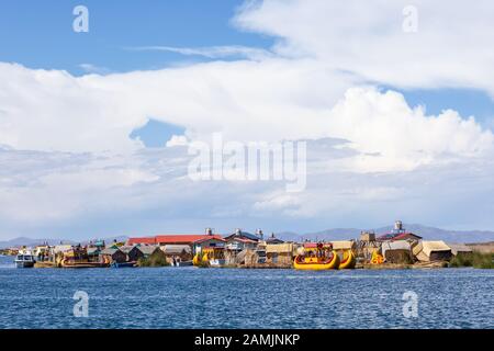 View of the floating islands of Uros, at a distance, clouds, on Lake ...
