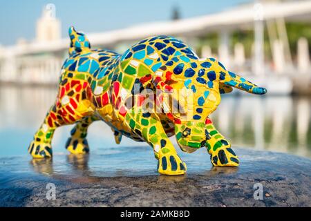 Traditional spanish souvenir - ceramic bull on a promenade in Malaga ...