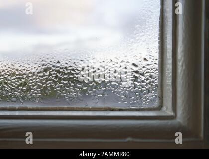 window with water droplets of humidity condensation on window seen from ...