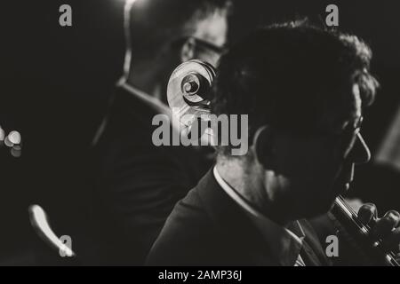 Symphonic orchestra performing on stage and playing a classical music ...