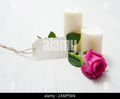 Rose with a gift card and candles. Romantic composition Stock Photo - Alamy