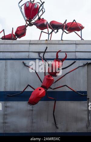 Red ant sculptures crawling over a train carriage at a restaurant in ...