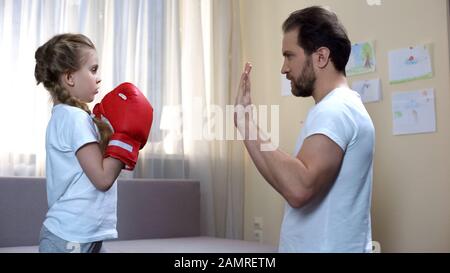 Father teaching daughter boxing Stock Photo - Alamy