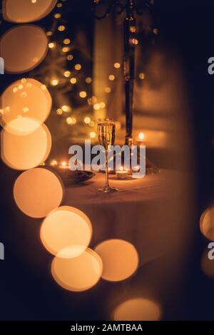 Glass of champagne and a burning candle on a blurred background Stock ...