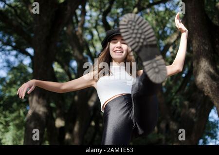 Girl kicking with her leg in camera, sole close up. Foreground focus ...