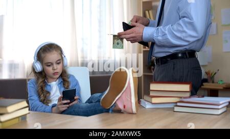 Father giving daughter pocket money Stock Photo - Alamy