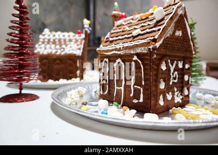 Gingerbread house and Christmas trees on a luminous background. Bokeh ...