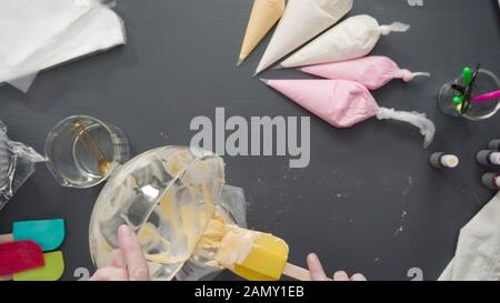Step by step. Flat lay. Pouring royal icing into the piping bag to ...