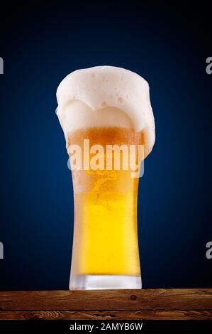 Glass of beer on the blue background Stock Photo - Alamy