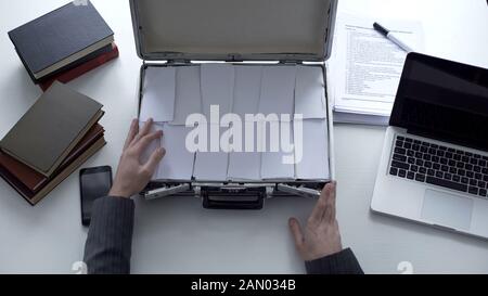 Man opening briefcase with papers instead of money, business fraud ...