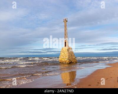 landscape with old and crooked lighthouse by the sea, windy day by the ...