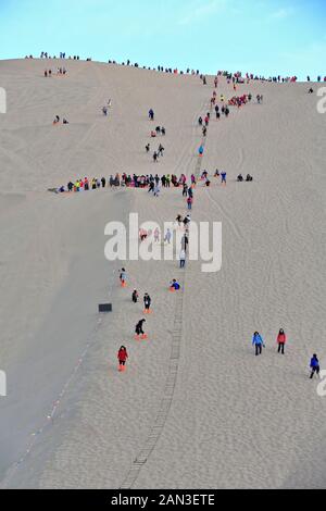 Sled-riders on the dunes around Crescent lake-Yueyaquan oasis. Dunhuang ...