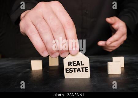 Little model house in hand in a paper box Stock Photo - Alamy