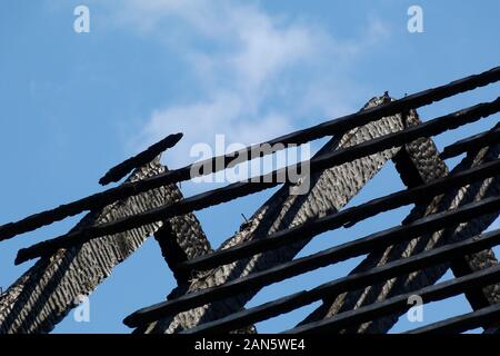 damaged exposed charred burnt black timber roof structure after house ...
